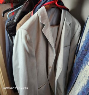 a12- Closet of mens clothing, knitted blankets. Very nice suits ...